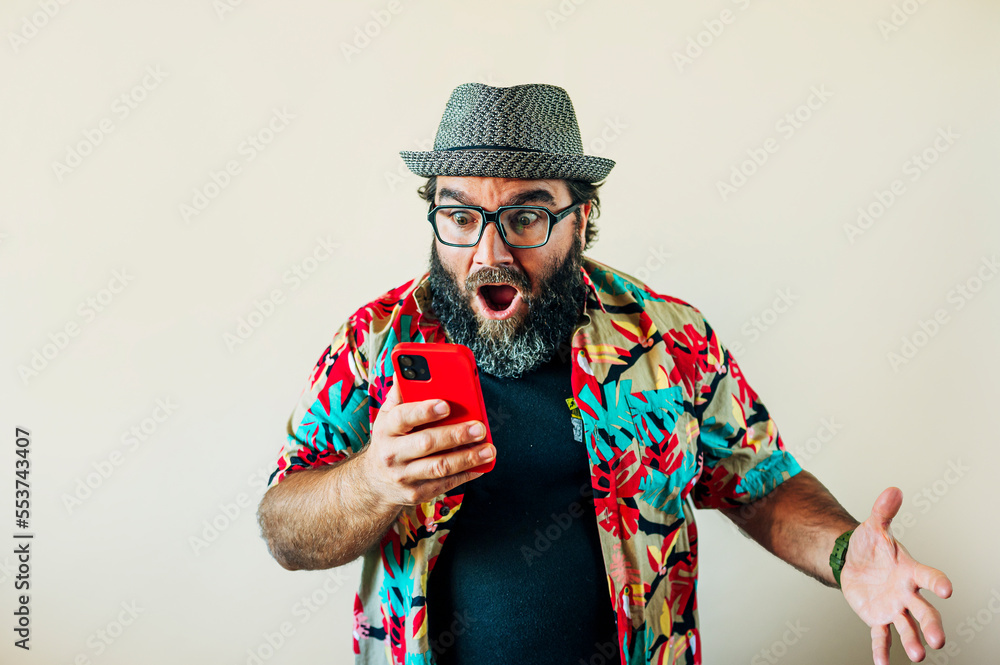 Fat man with a beard and elated with smart phone. Stock Photo | Adobe Stock