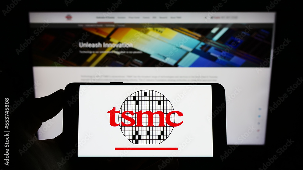 Stuttgart, Germany - 11-30-2022: Person holding mobile phone with logo of Taiwan Semiconductor ...