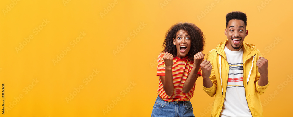 Two friends cheering and supporting mate on competition yelling ...