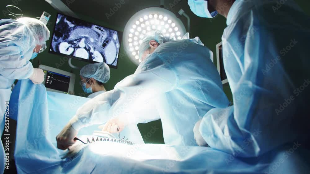 Group of multiethnic concentrated doctors reanimating patient lying in ...