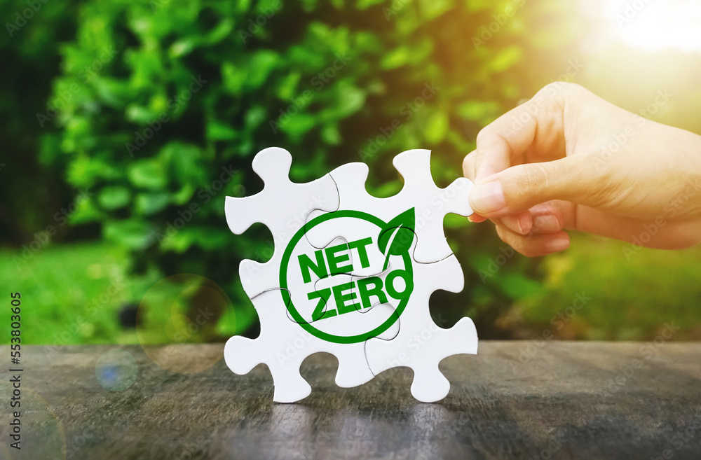 Hand picking jigsaw with netzero icon on natural background, Zero ...