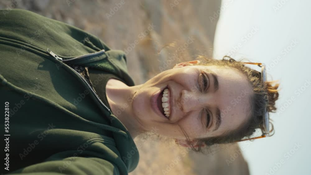 Vidéo Stock Vertical video - Young woman holding phone in selfie and ...