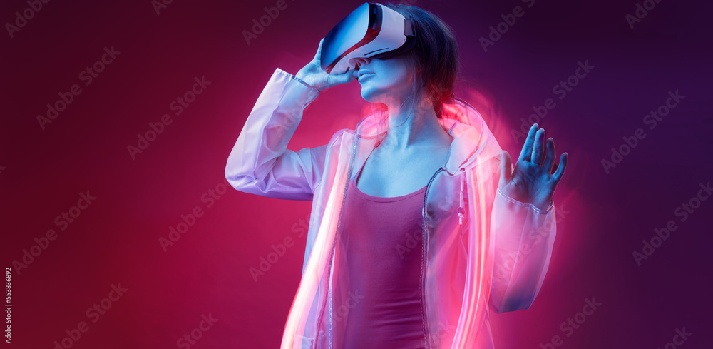 Woman in futuristic costume. Girl in glasses of virtual reality while ...