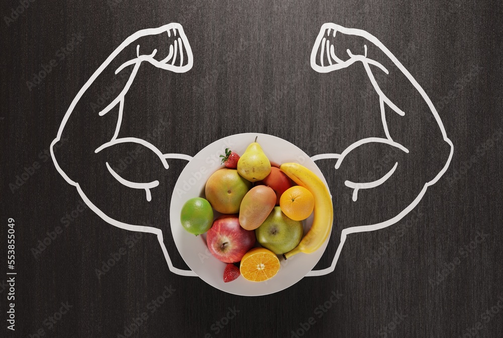 Muscles on the background of a plate with different fruits. The concept ...