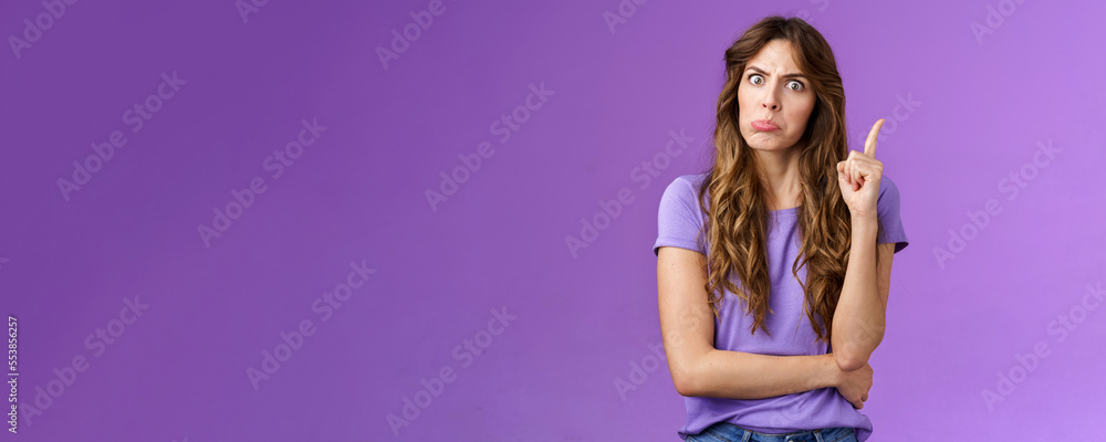 Strict funny curly-haired girl pulling disappointed angry face popping ...