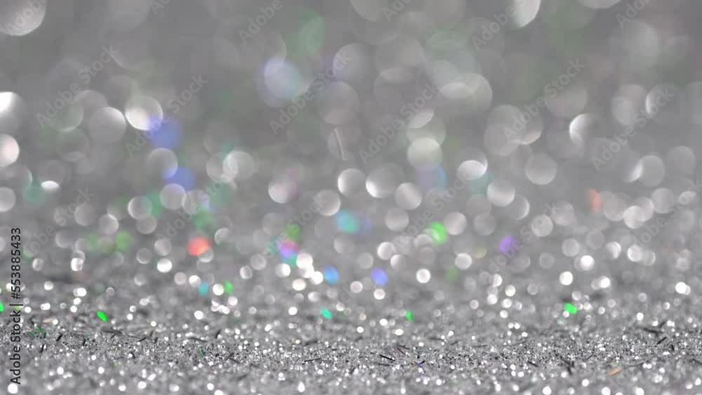 Shiny silver holographic surface with sequins. Magic bokeh background ...