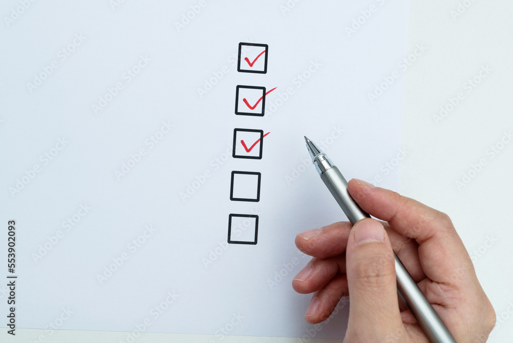 Red pen marking on checklist sheet Stock Photo | Adobe Stock