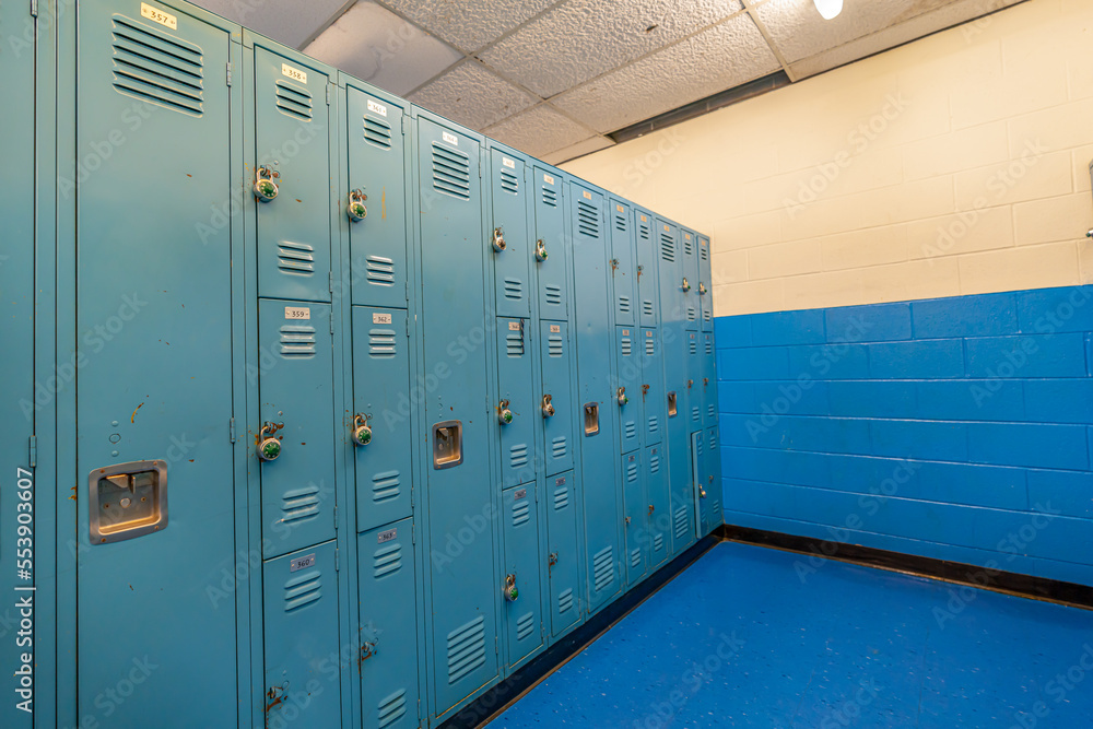 Nondescript locker room with old blue metal gym, gymnasium, lockers ...