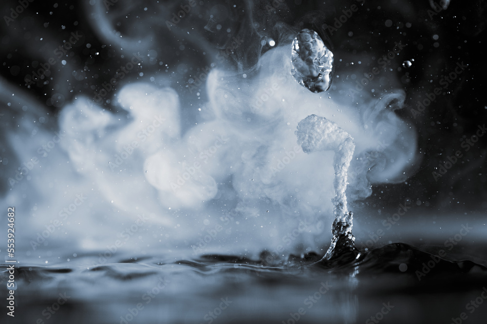 Boiling water splash with steam on black background closeup Stock Photo ...