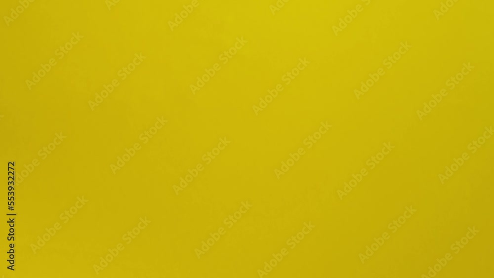 Hands holding cell phone with green screen on yellow background. Chroma ...