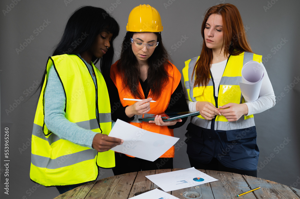 Group of multiracial females architects discussing and together about ...