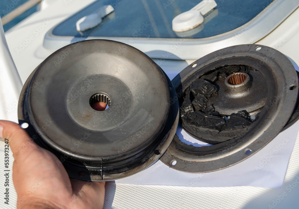 A new ready-to-replace and old damaged damper disc from the marine ...