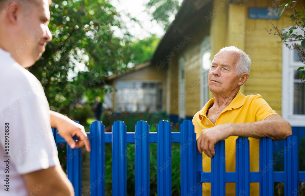 Old man talking with his neighbour Stock Photo | Adobe Stock