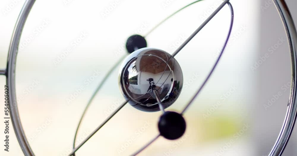 Cropped view rotating table pendulum balls anti stress in the tropical ...