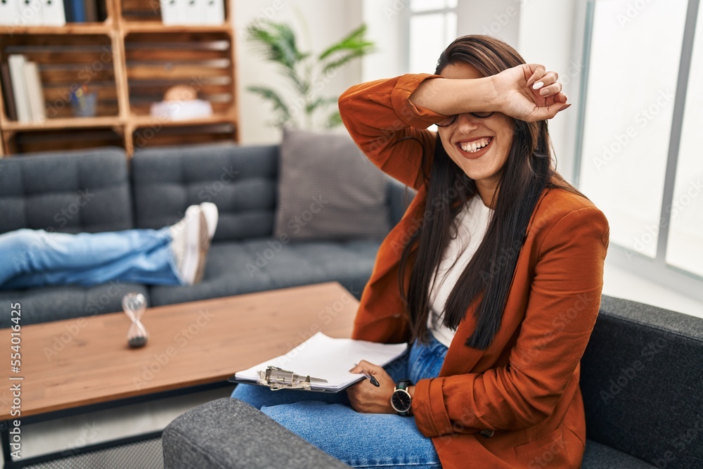 Young hispanic woman working as psychology counselor smiling cheerful ...