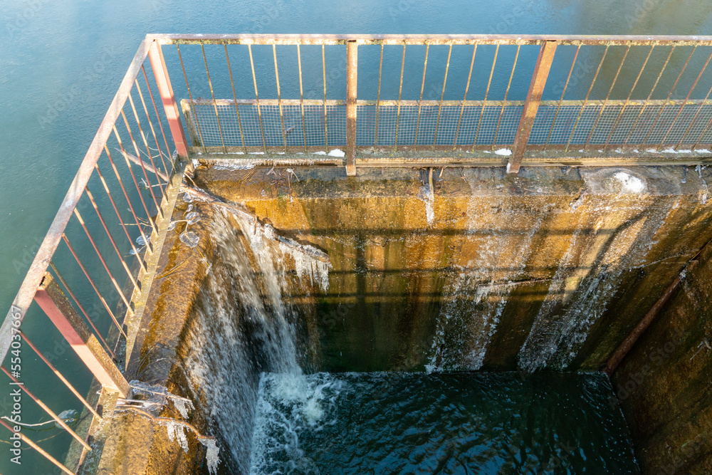 Discharge of sewage into the river. The spillway on the dam for the ...