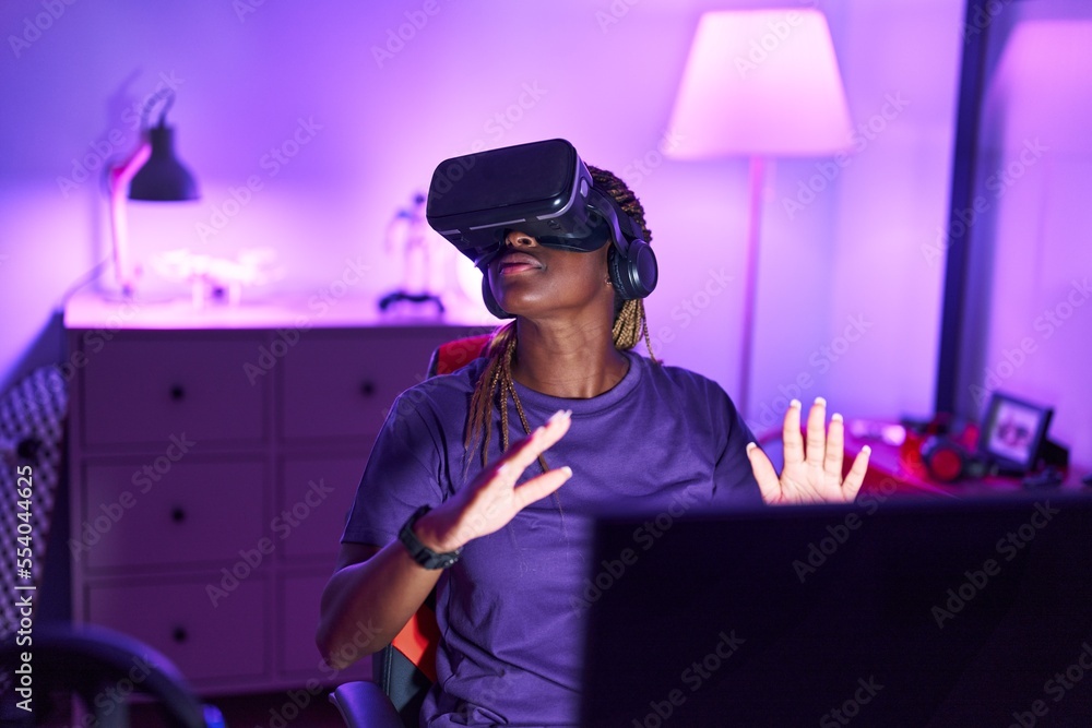 African american woman streamer playing video game using virtual ...