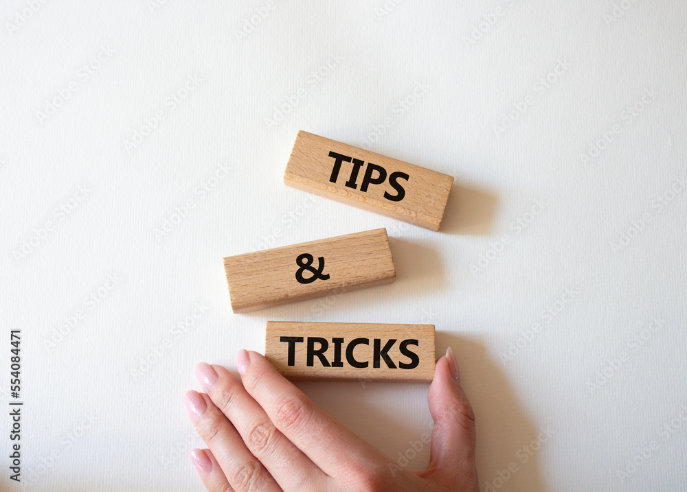 Tips and tricks symbol. Wooden blocks with words Tips and tricks. Beautiful white background ...