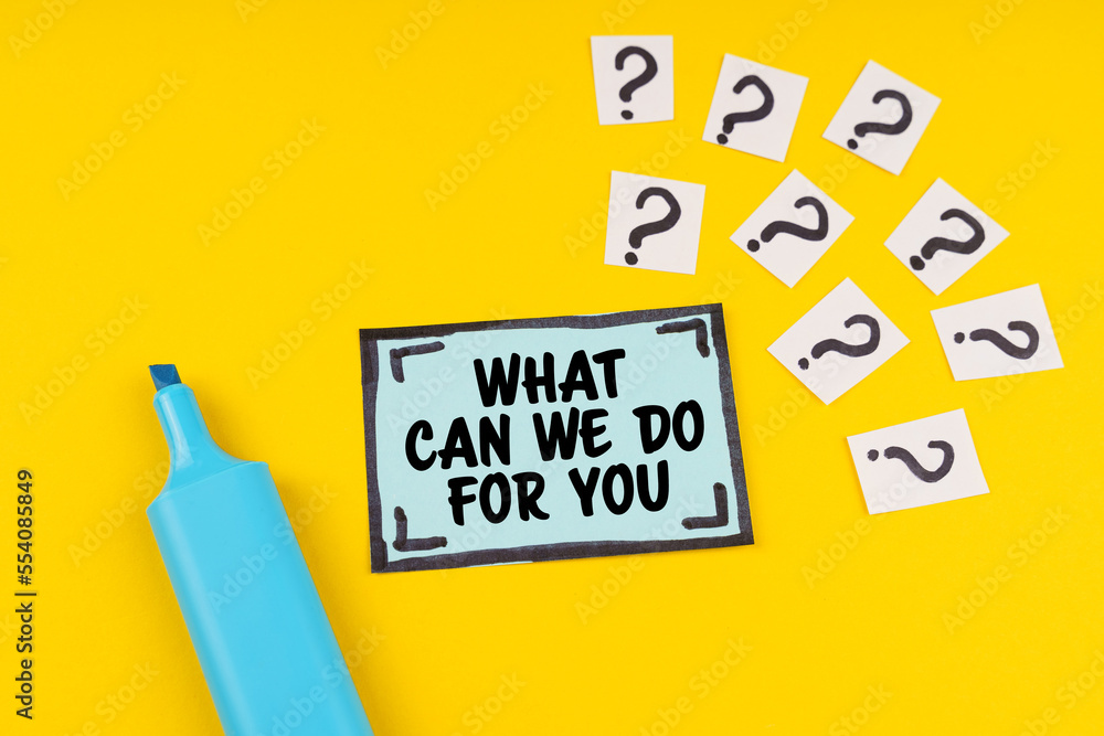 On the yellow surface is a marker, question marks and a sticker with ...