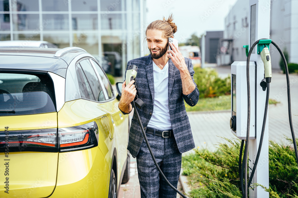 Electric car charging concept. How it works. Funny man with charging ...