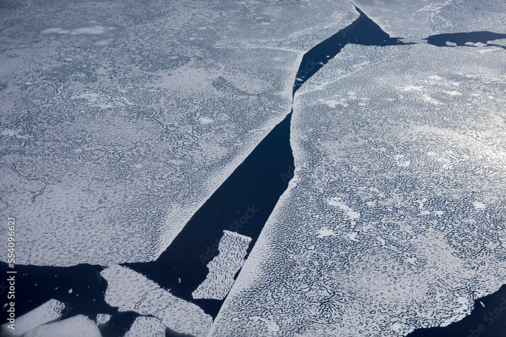 A large detached piece of sea ice breaks away from the main structure ...