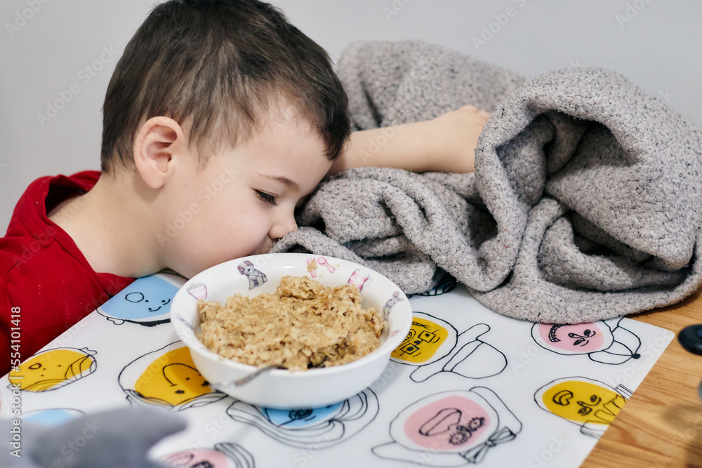 cute young boy being patient while waiting for his food to cool down ...