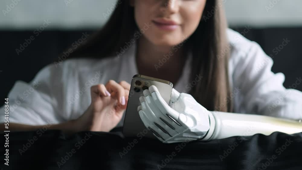 Girl with bionic arm using phone, reading social media and chatting in ...