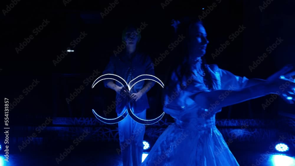 Light LED dance show. Impressive dances of two beautiful girls in ...