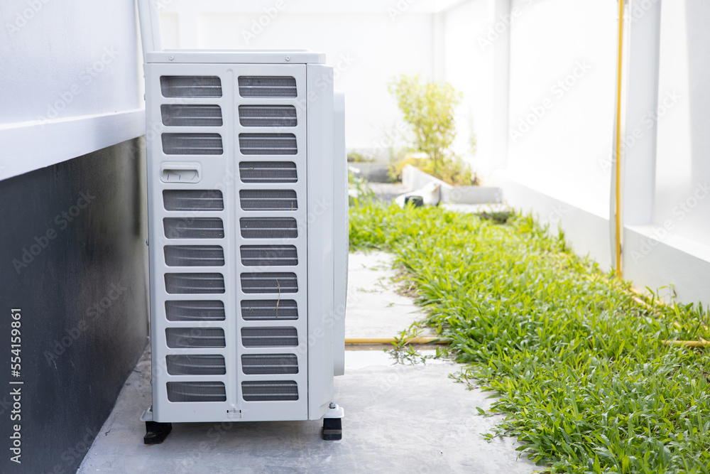 Side view of an air conditioner cooler installed on the exterior floor ...