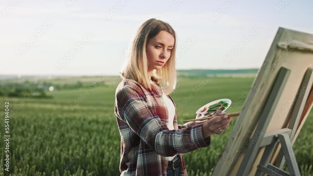 Side view of seductive, blonde woman holding brush and color palette ...
