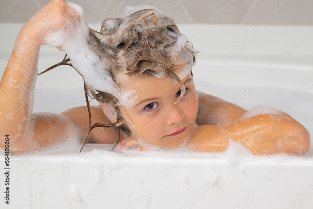 Kids bathing. Child in the bath with bubbles. Happy child enjoying bath ...