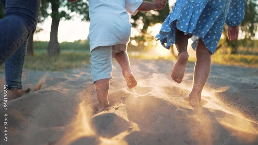 Happy family. Active children run together on sand with bare feet ...