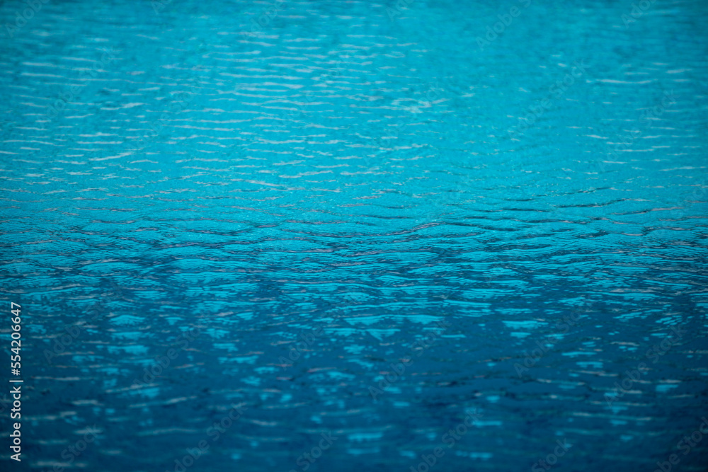 Ripped water in swimming pool. Surface of blue swimming pool ...