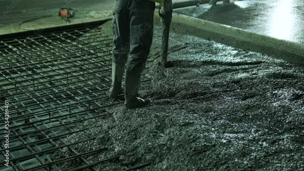 Reinforced concrete. Worker concretes foundation, rebar, pour cement ...