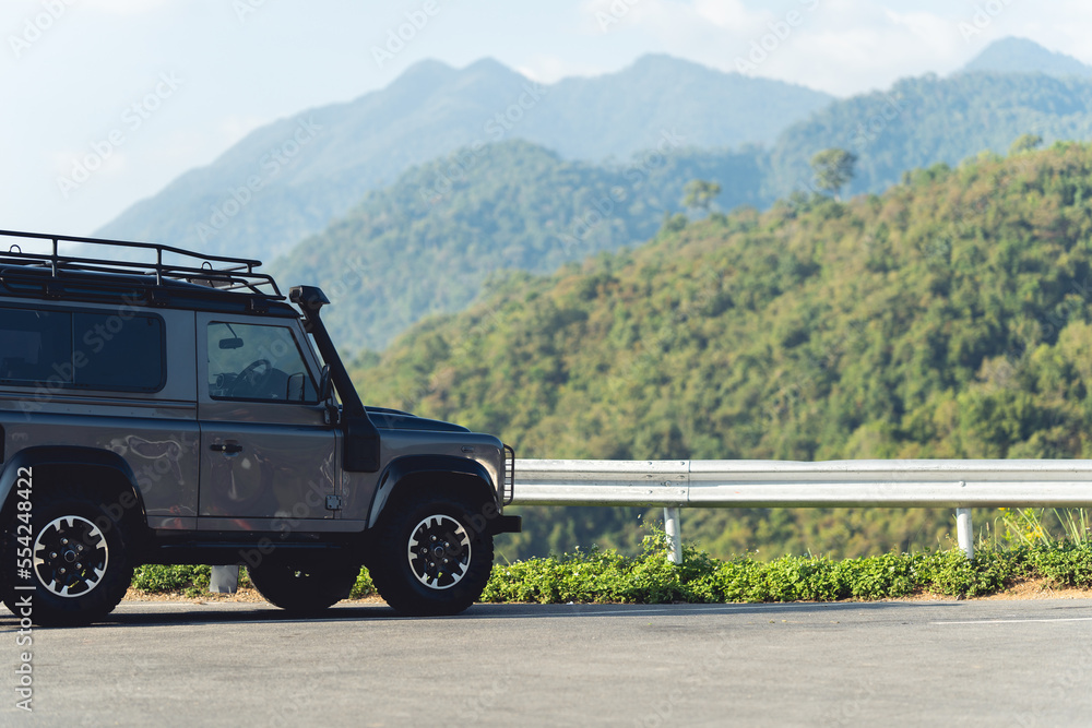 Off-road vehicles parked on dry paved roads. Side view There is a ...