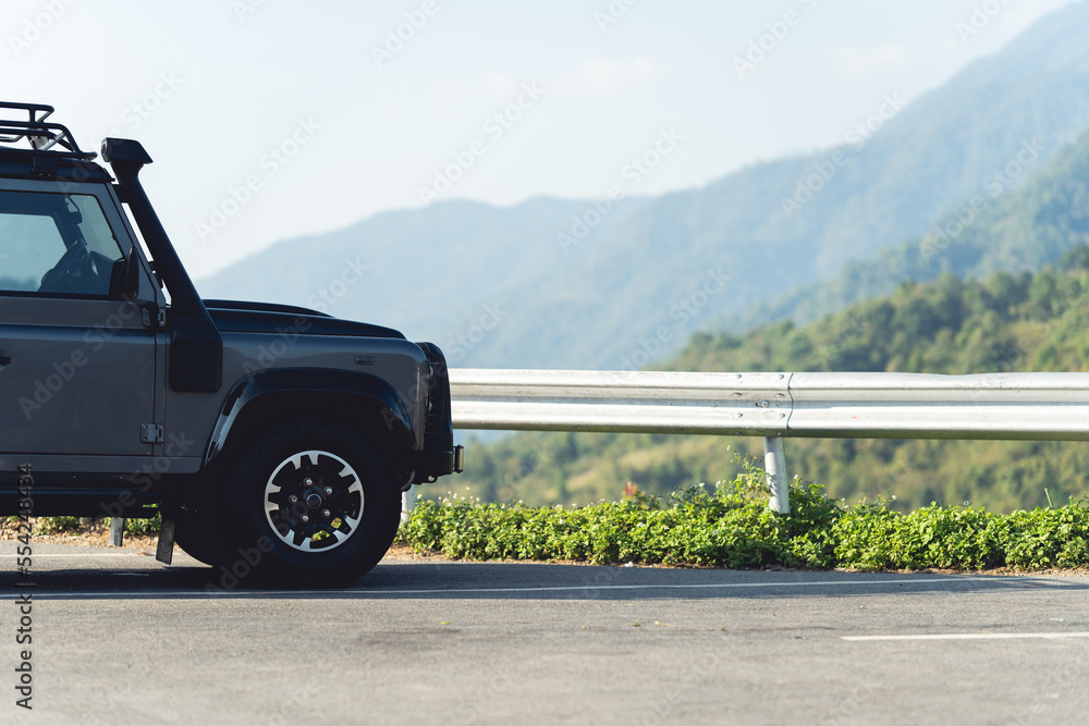 Off-road vehicles parked on dry paved roads. Side view There is a ...