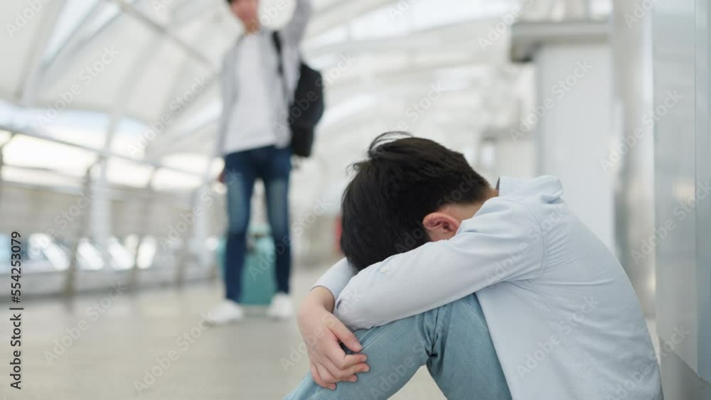 Son sitting on the floor and waiting father come back from business ...