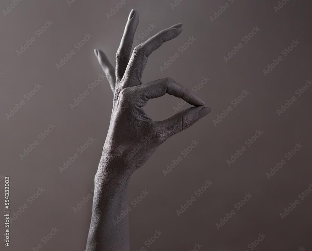 Ok sign. Hand okay positive gesture. Black painted woman's hand giving ...