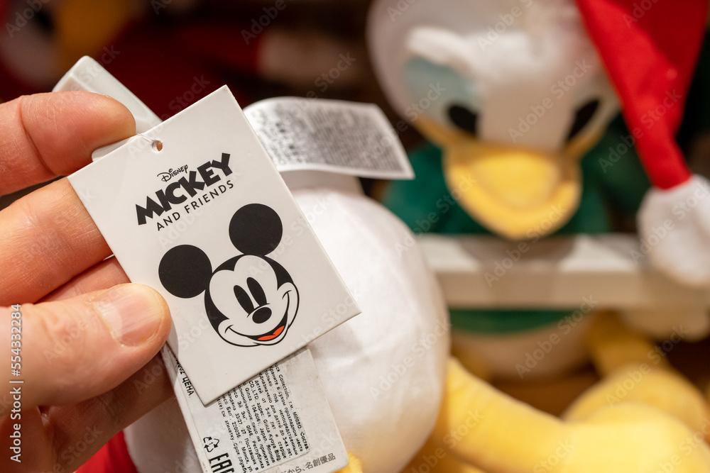 Disney toy label with company logo in the hands of a customer in a ...