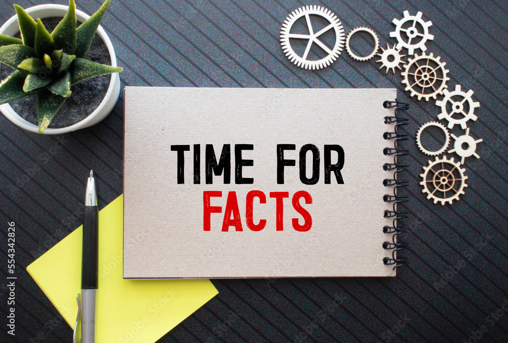 Notepad with text TIME TO FACTS with a pen,office tools and graphs on ...