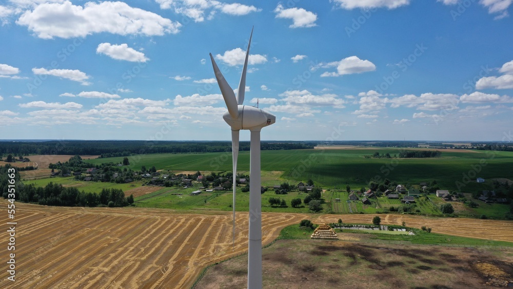Side view of a huge windmill. Windmill turbine blades on the side ...