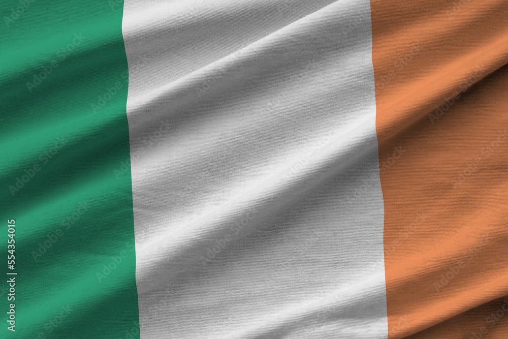 Foto de Ireland flag with big folds waving close up under the studio ...