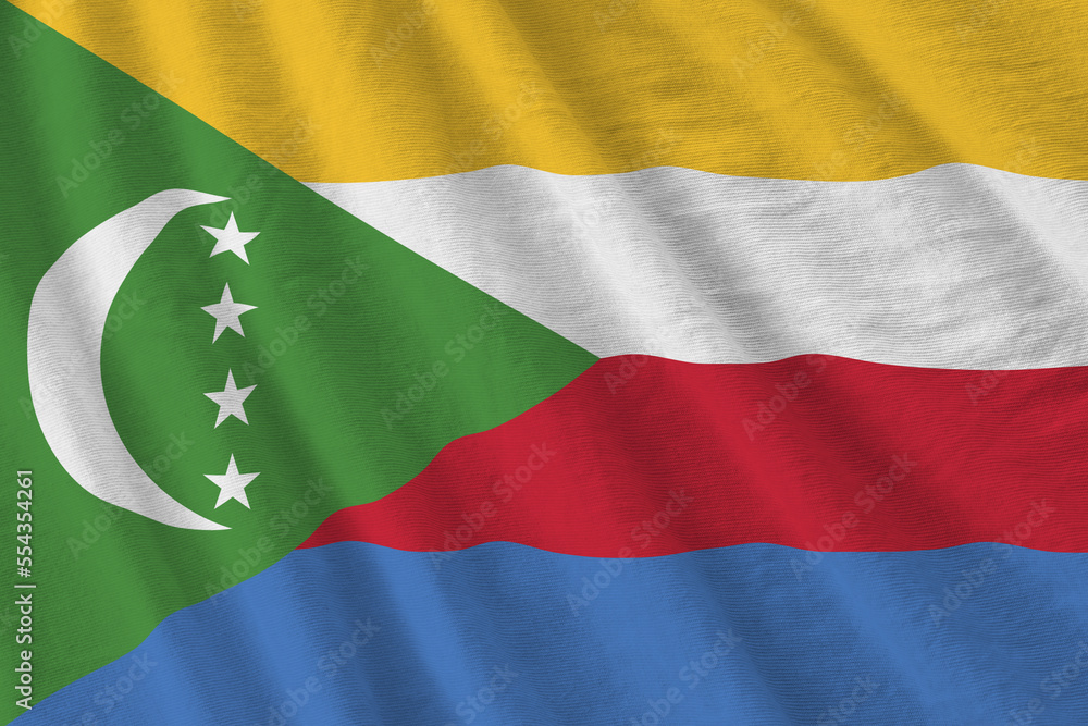 Comoros flag with big folds waving close up under the studio light ...