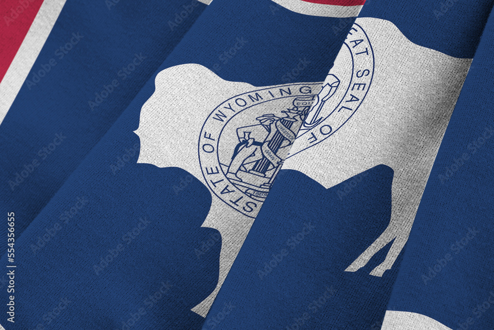 Wyoming US state flag with big folds waving close up under the studio ...