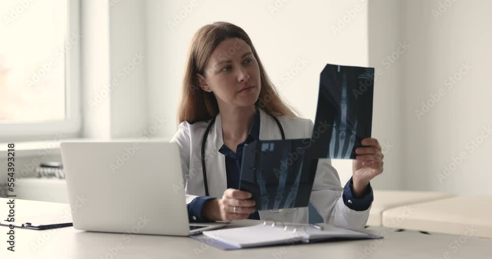 Focused woman radiologist in white coat, female doctor specializing in ...