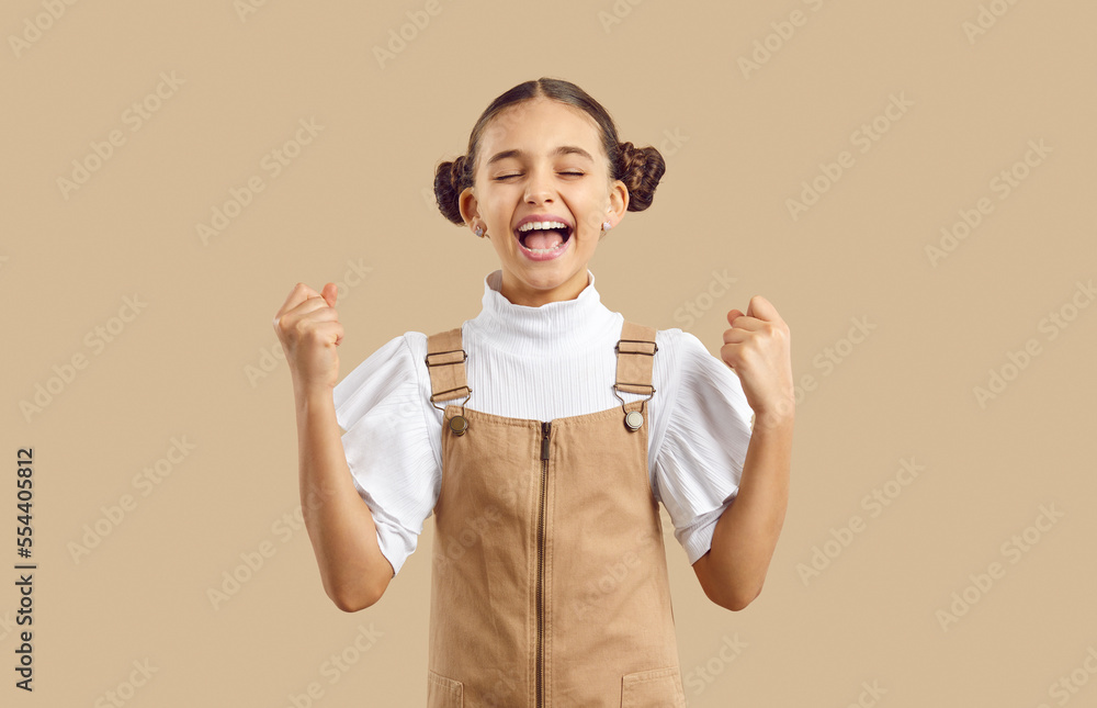 Happy child is happy to succeed and win. Joyfully excited prteen girl ...