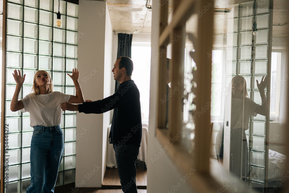 Remote view of stressed young couple quarreling and fighting, yelling ...