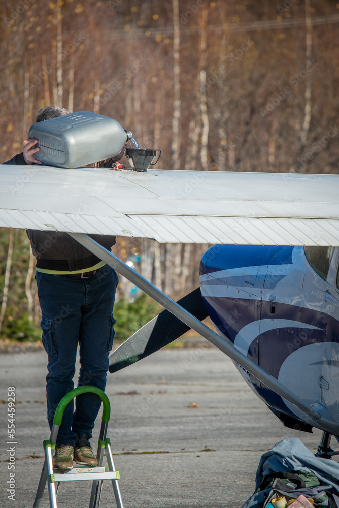 Refueling of a light-engine aircraft from a canister with fuel. Stock ...
