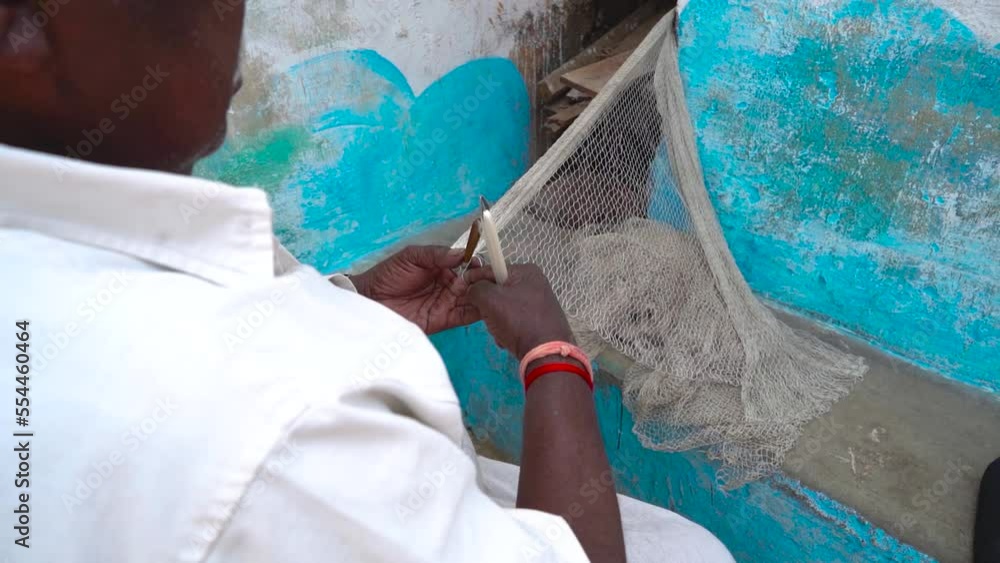 An old man making net with his hands to catch fish in pond, Old man of ...