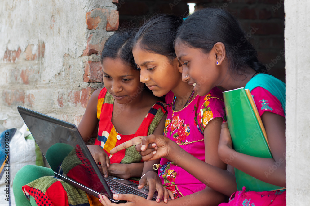 School Students Girls using laptop while studying at home Stock Photo ...